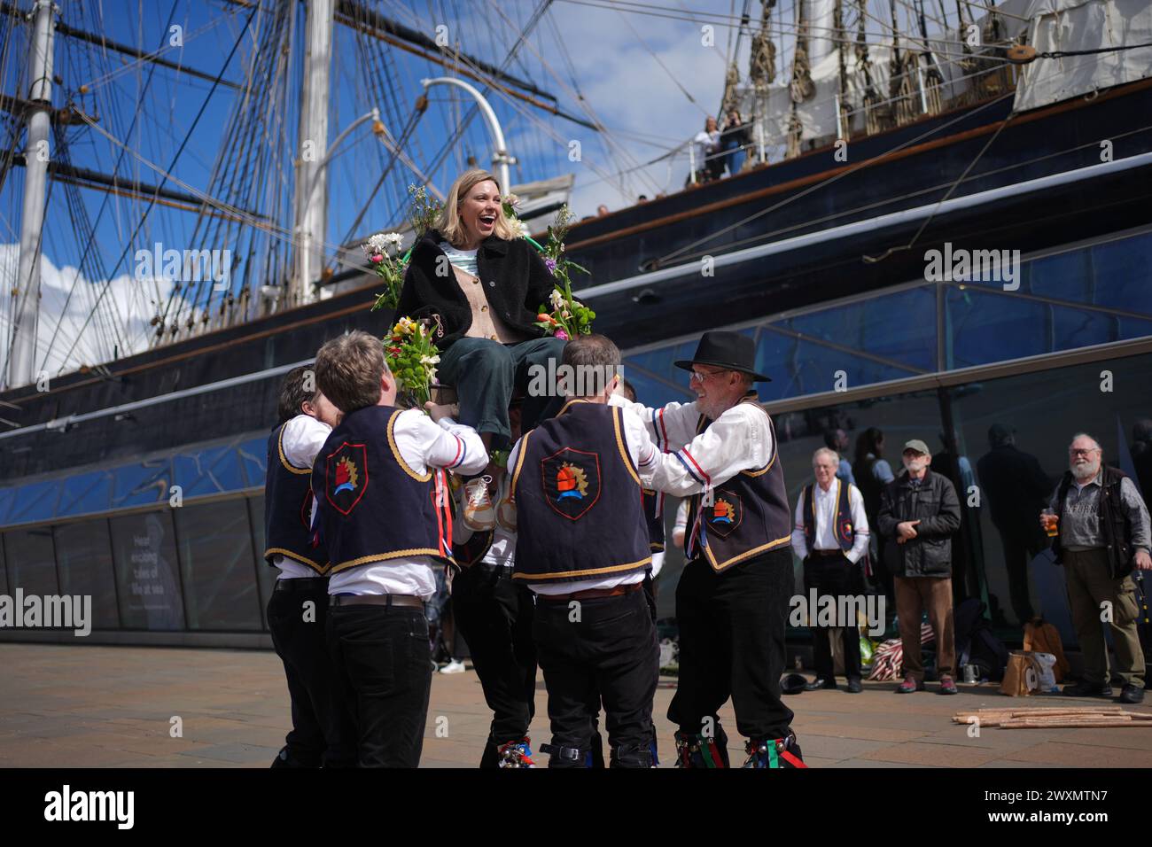 Members of the Blackheath Morris Men lift Poppy Trevillion, from London ...
