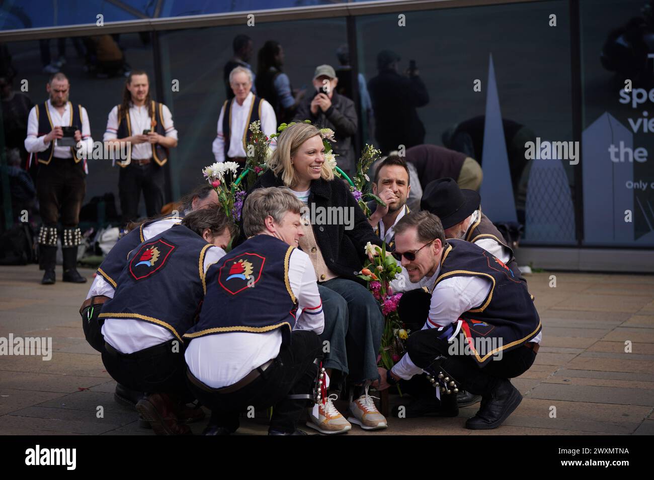 Members of the Blackheath Morris Men lift Poppy Trevillion, from London ...