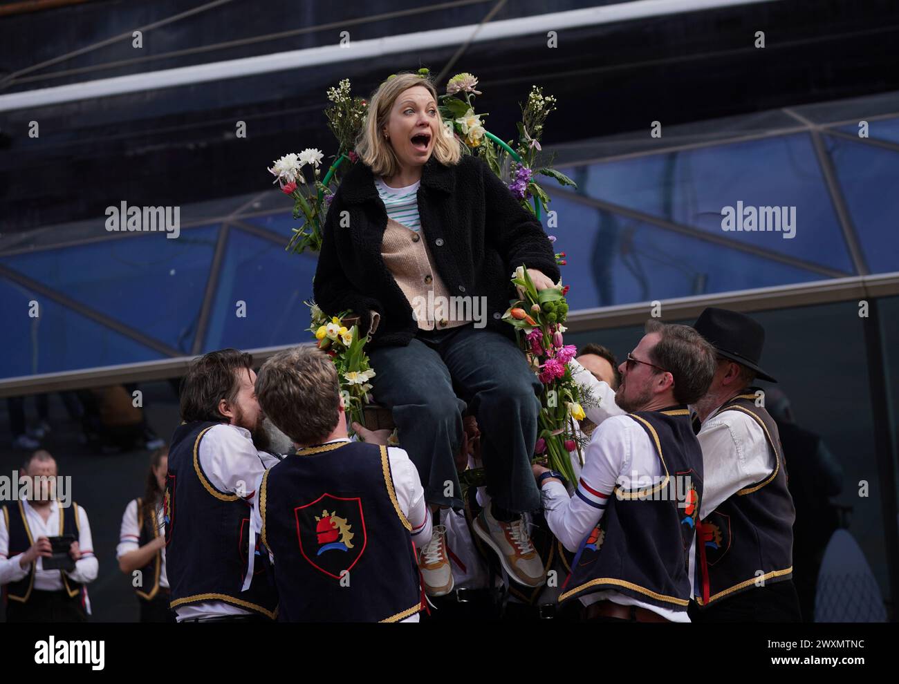 Members of the Blackheath Morris Men lift Poppy Trevillion, from London ...