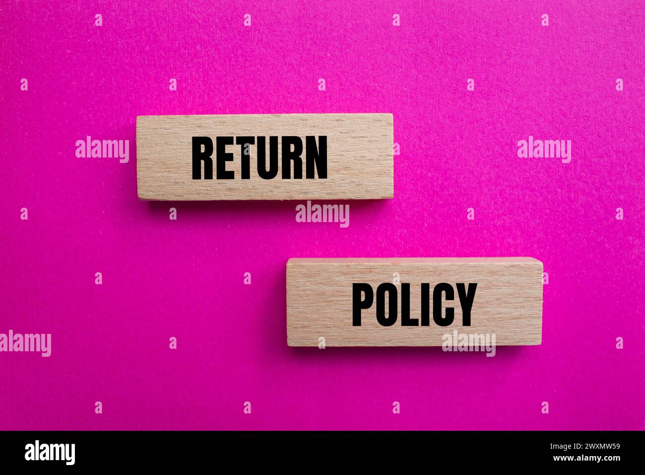 Return policy words written on wooden blocks with pink background ...