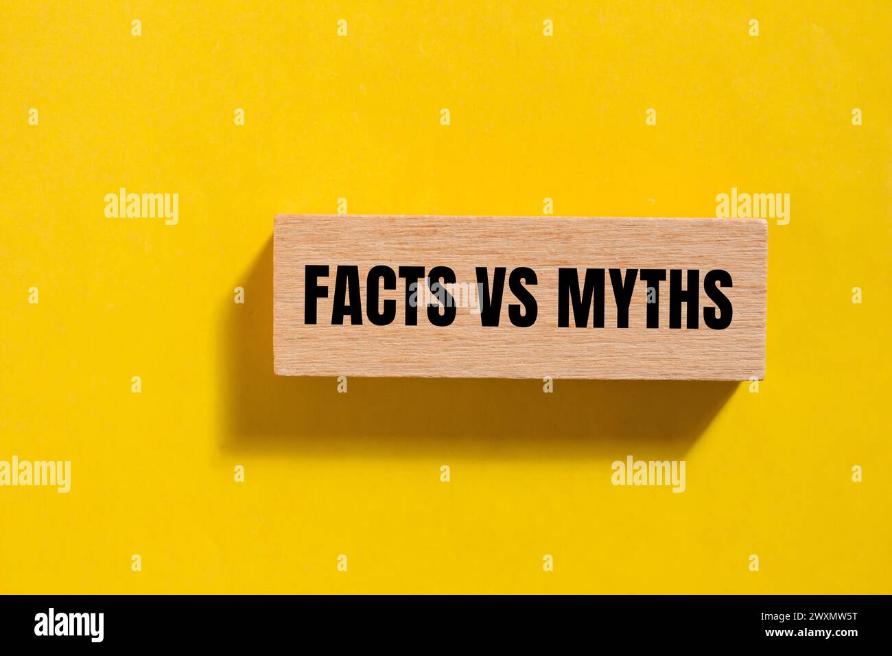 Facts vs myths words written on wooden block with yellow background ...