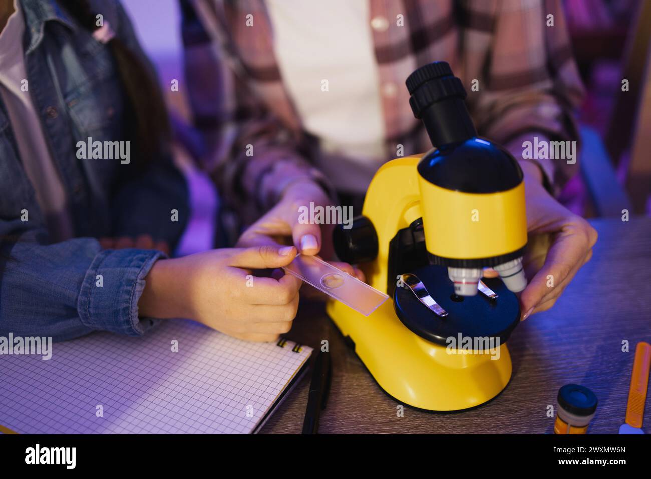 Close up of hands of mother controlling process of creating of ...