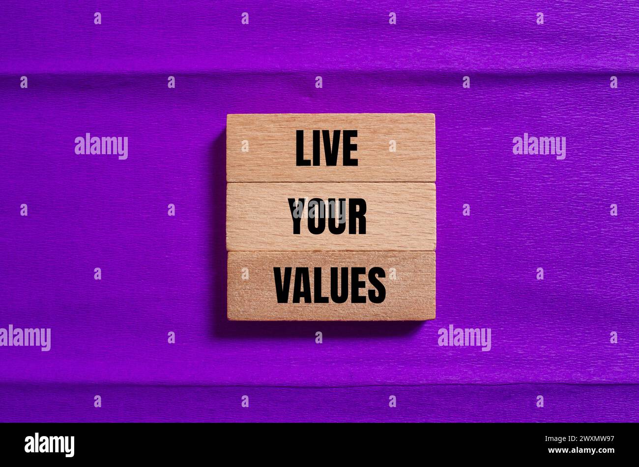 Live your values words written on wooden blocks with purple background ...