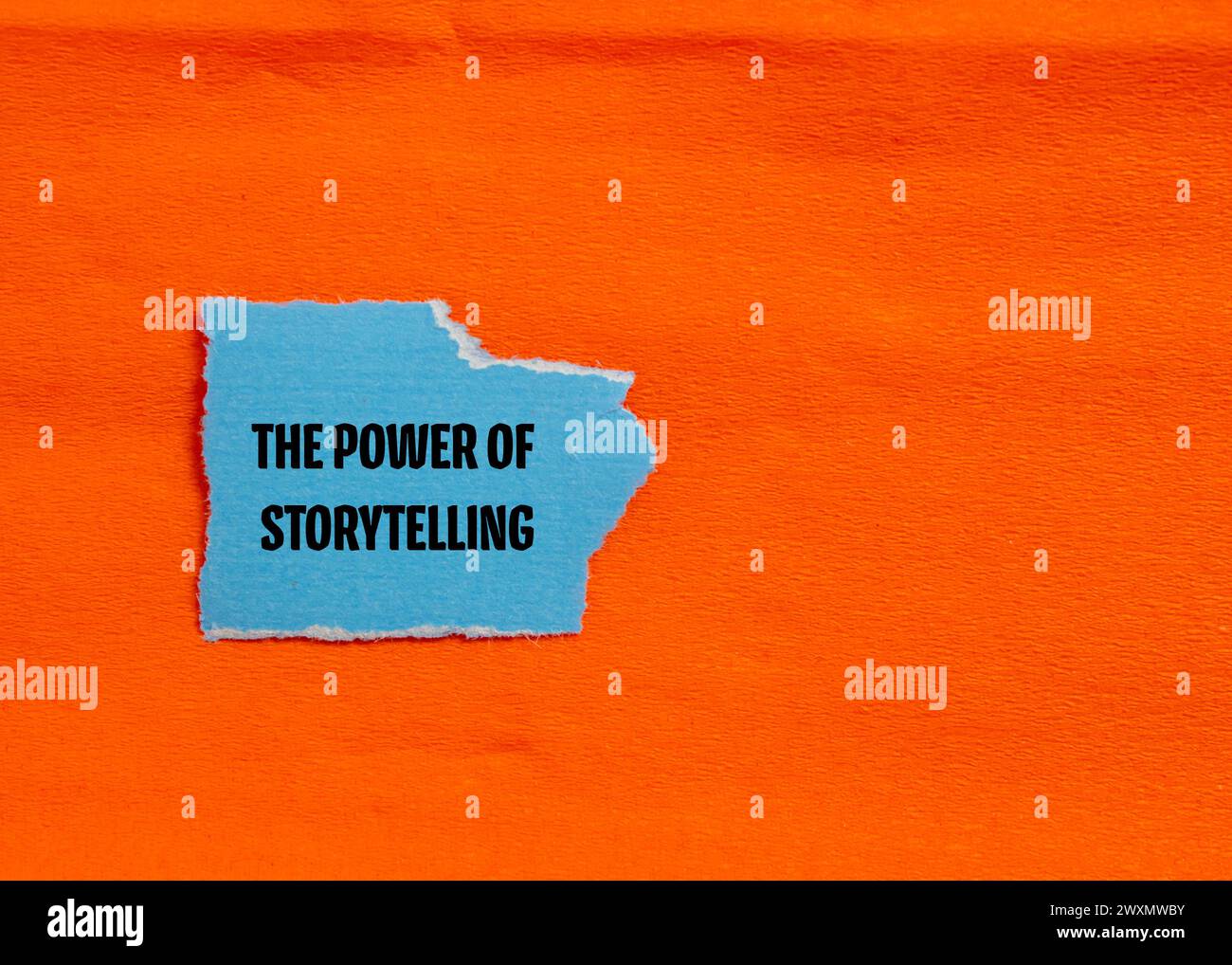 The power of storytelling words written on blue torn paper piece with ...