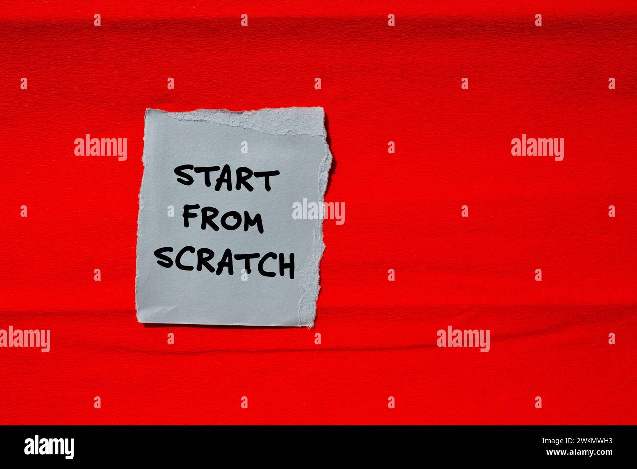 Start from scratch words written on torn paper piece with red ...