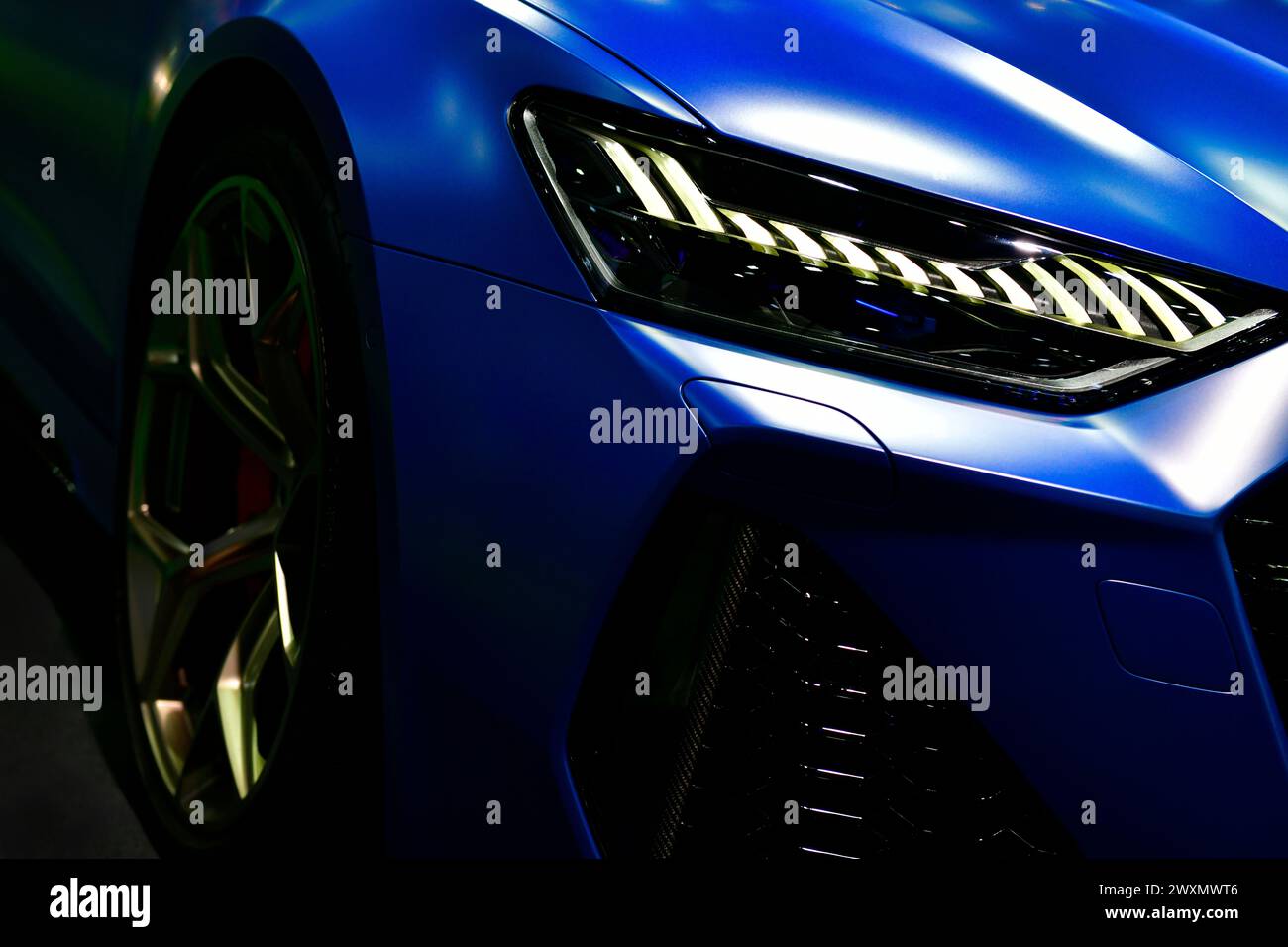 Front view of the LED headlights modern blue car Stock Photo - Alamy