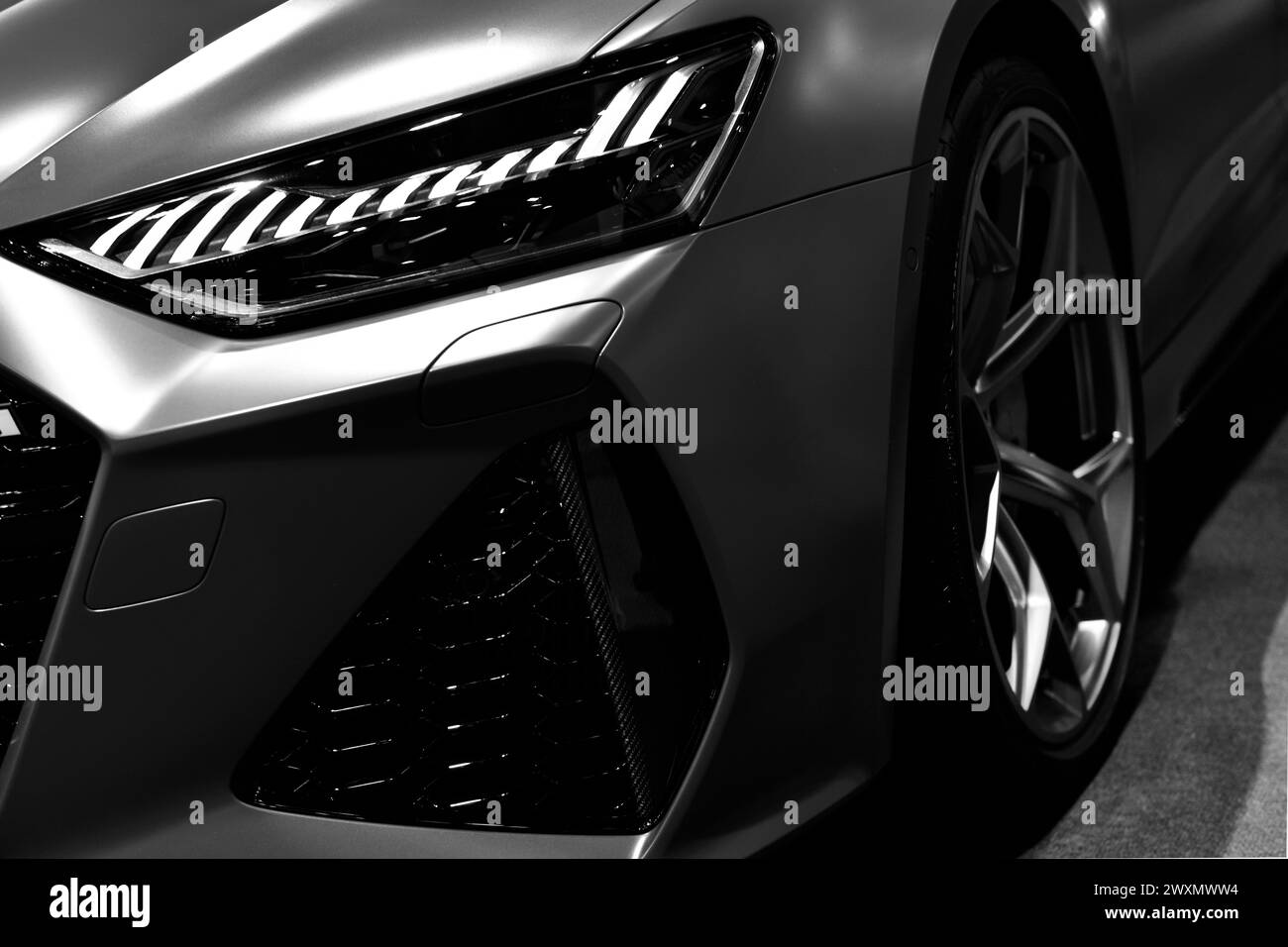 Front view of LED headlights sport car on black background, copy space ...
