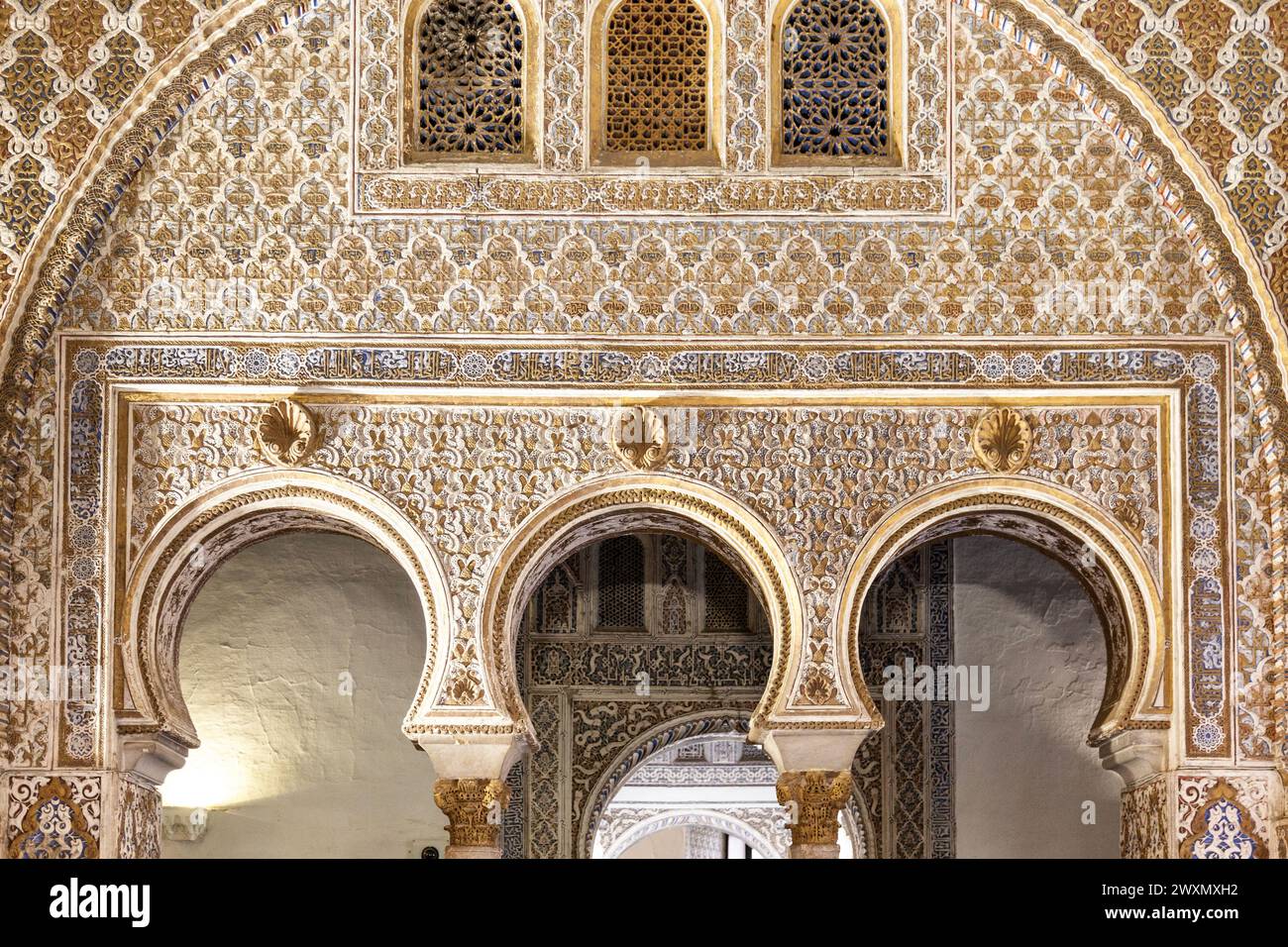 Ornate walls and keyhole arches of the Mudejar style Hall of ...