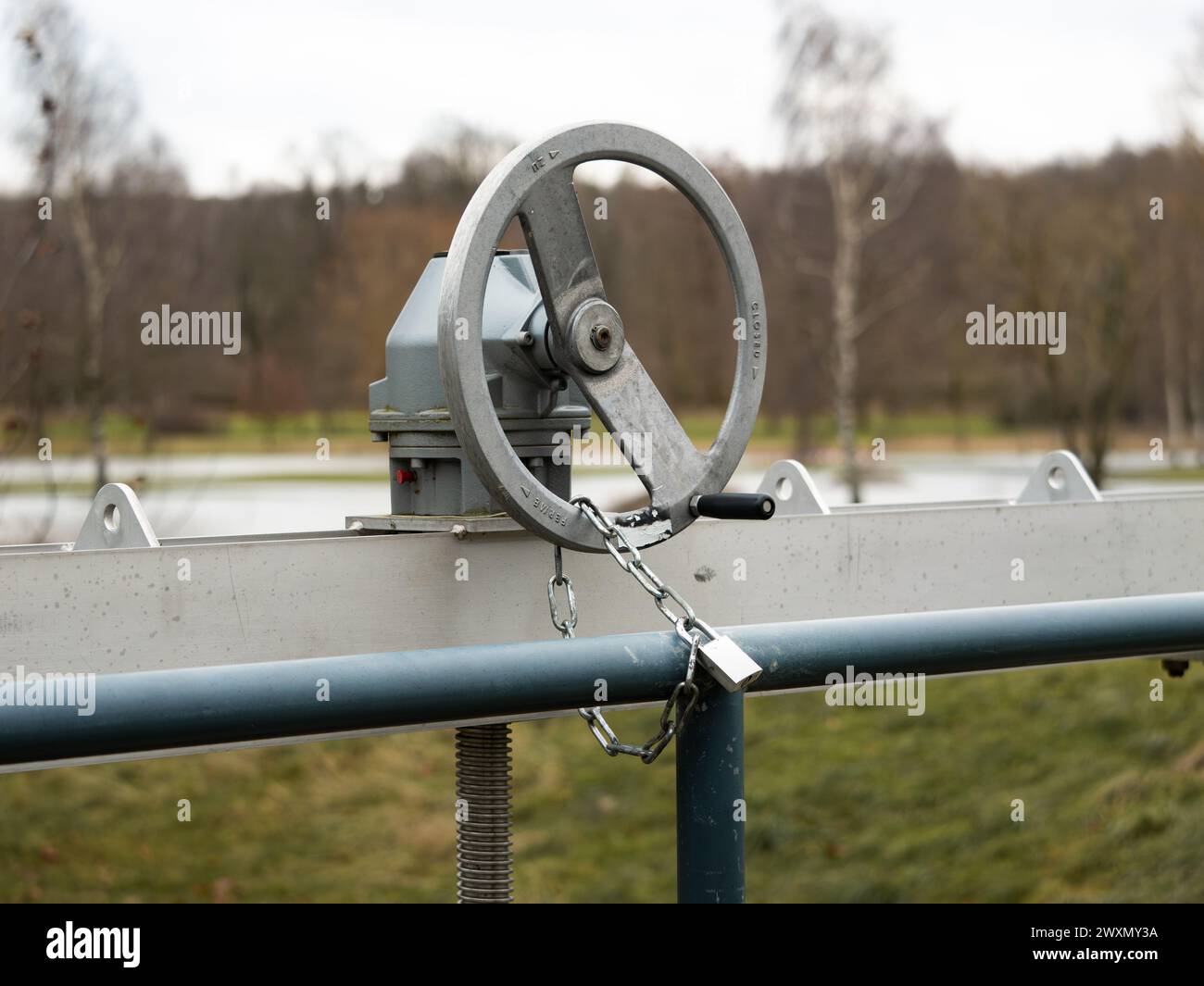 Hand crank wheel to open and close a floodgate. The rotation is blocked ...