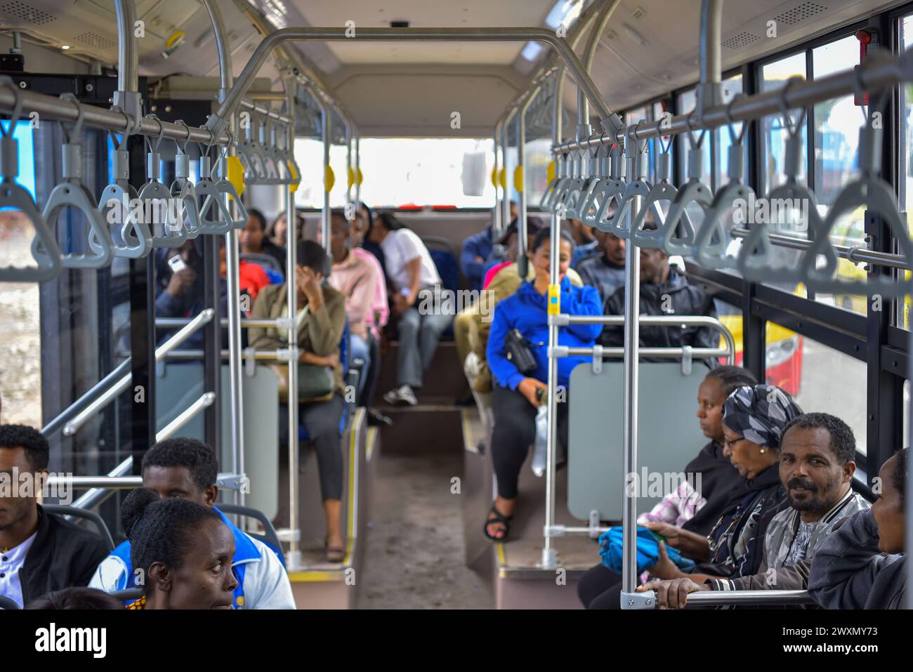 Addis Ababa, Ethiopia. 26th Mar, 2024. Passengers take an electric bus ...