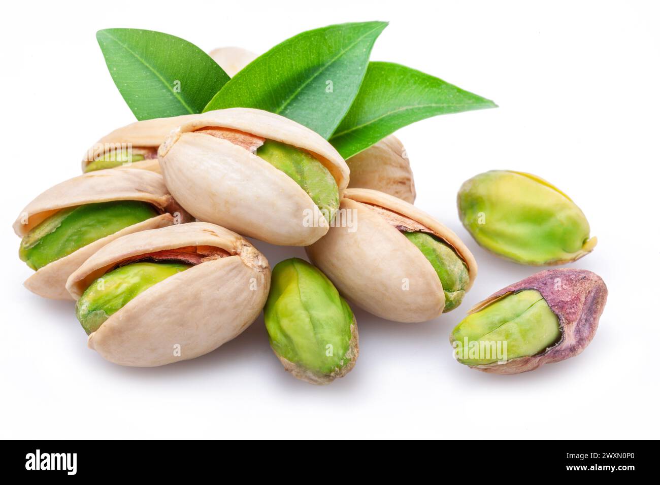 Fresh pistachio seeds with shell and leaves isolated on white ...