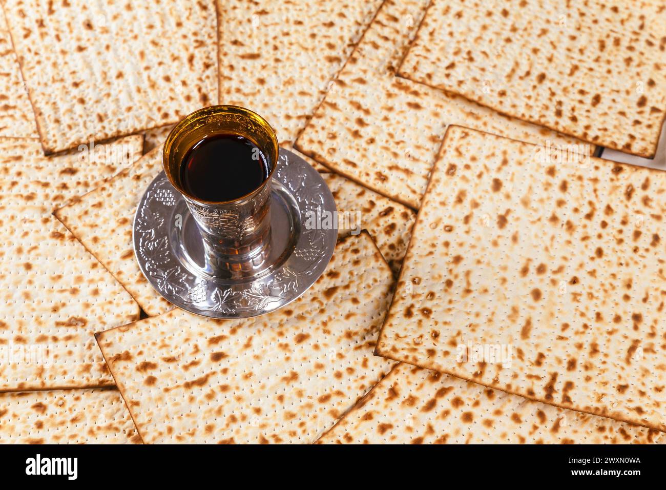 An unleavened Jewish matzah loaf wine cup with Passover holiday symbols ...