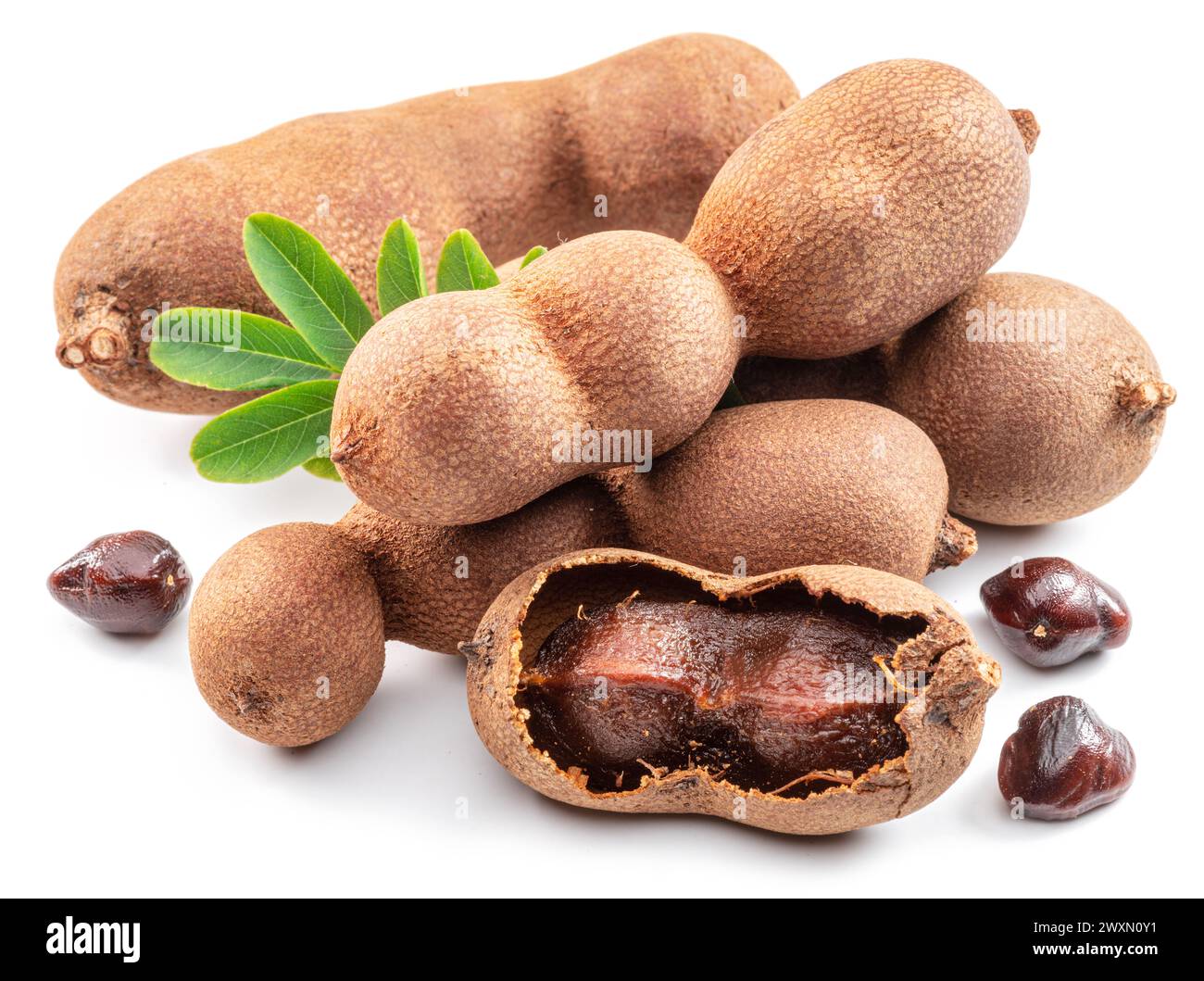 Tamarind fruits and one cracked tamarind with brown pulp in the ...