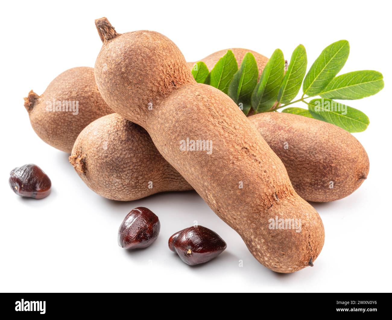 Ripe tamarind fruit, leaves and some tamarind seeds isolated on white ...