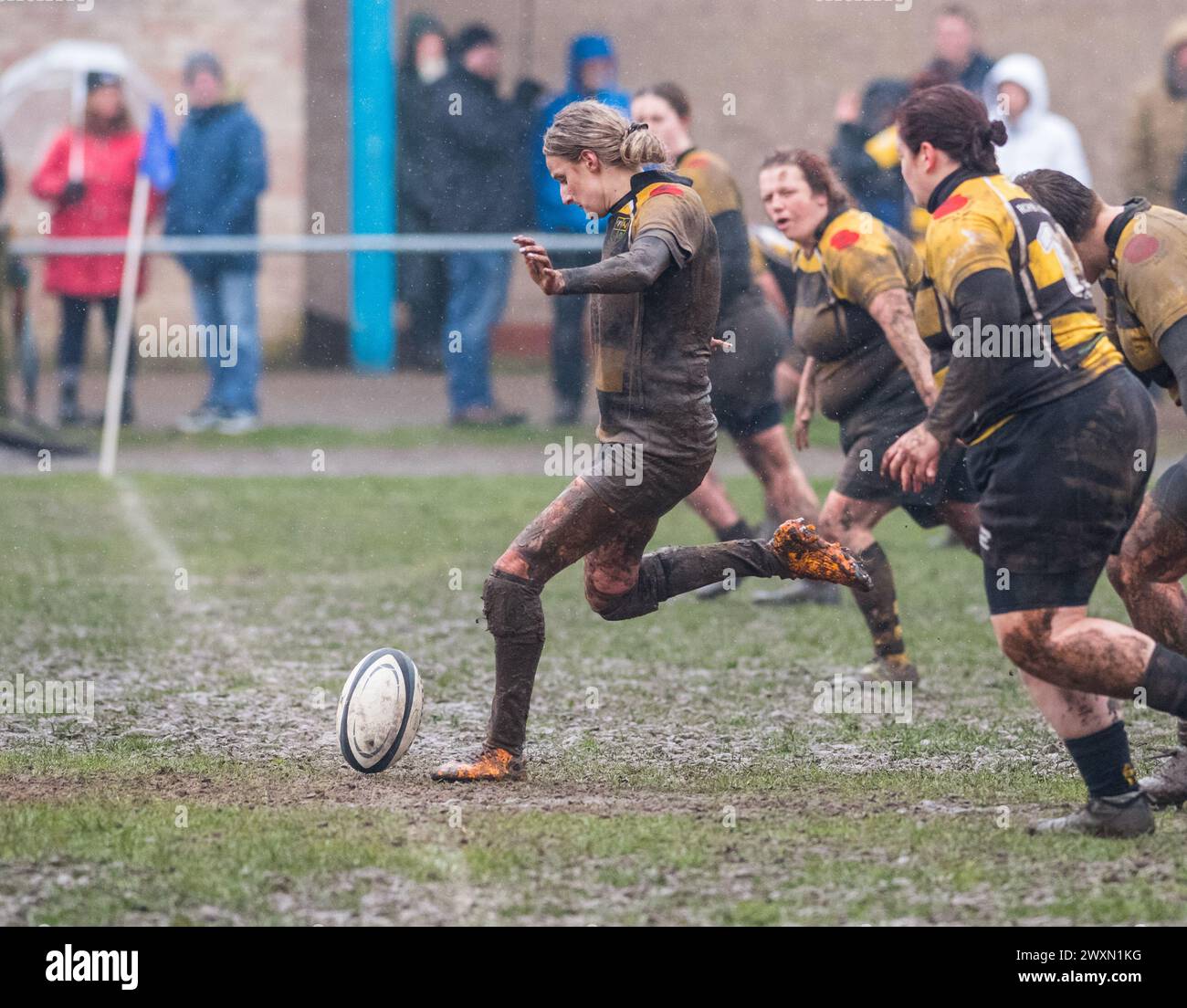 English amateur rugby union women's game playing in wet and muddy ...