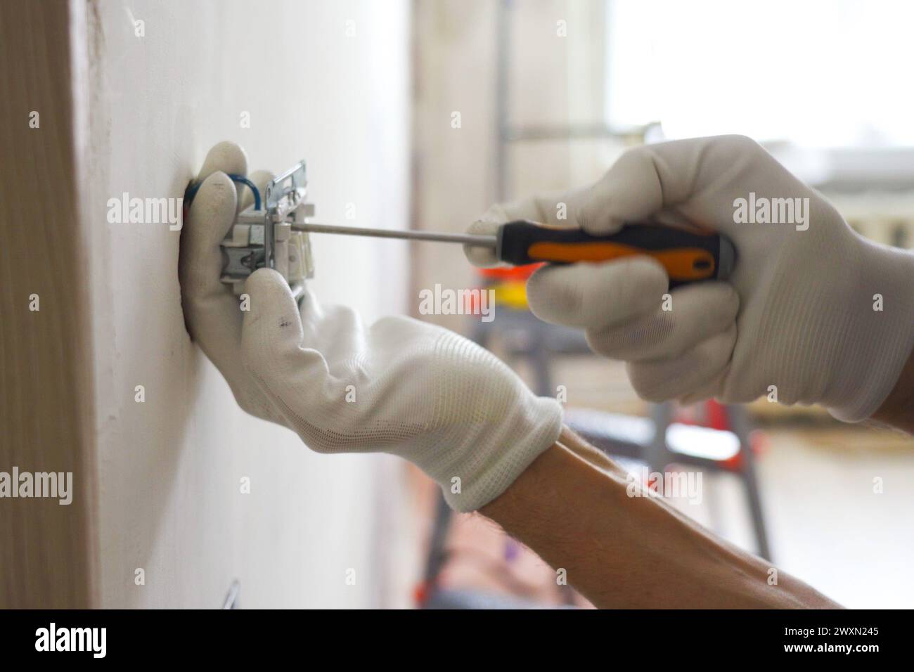 Installation of electric household socket on the wall during the ...