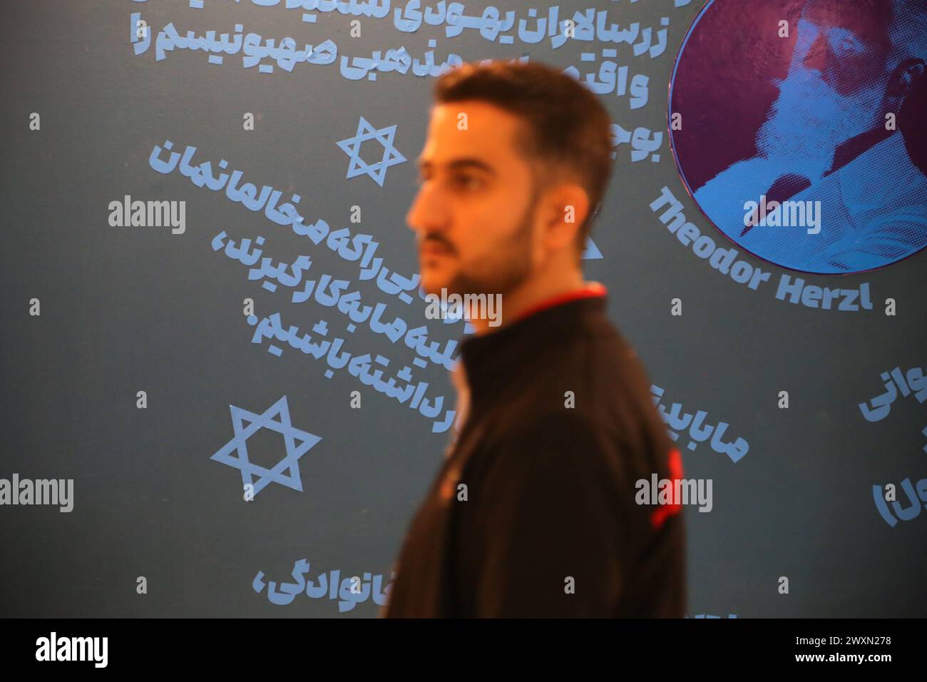 Tehran, Iran. 31st Mar, 2024. An Iranian man walks past the Star of ...