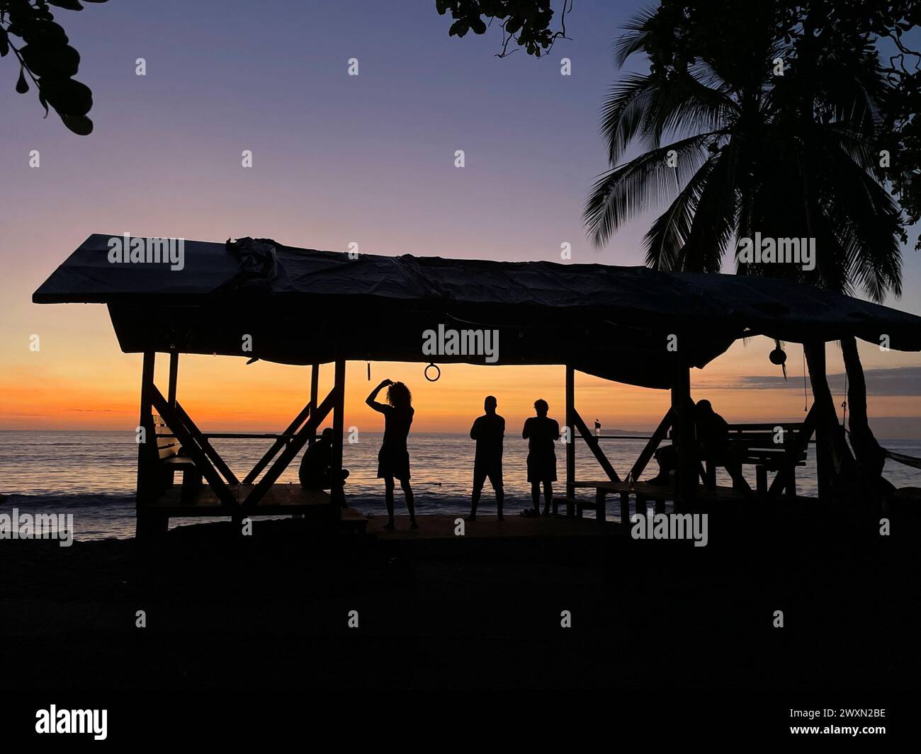 People at resort (Poor Man's Paradise) watching Sunset near Drake Bay ...