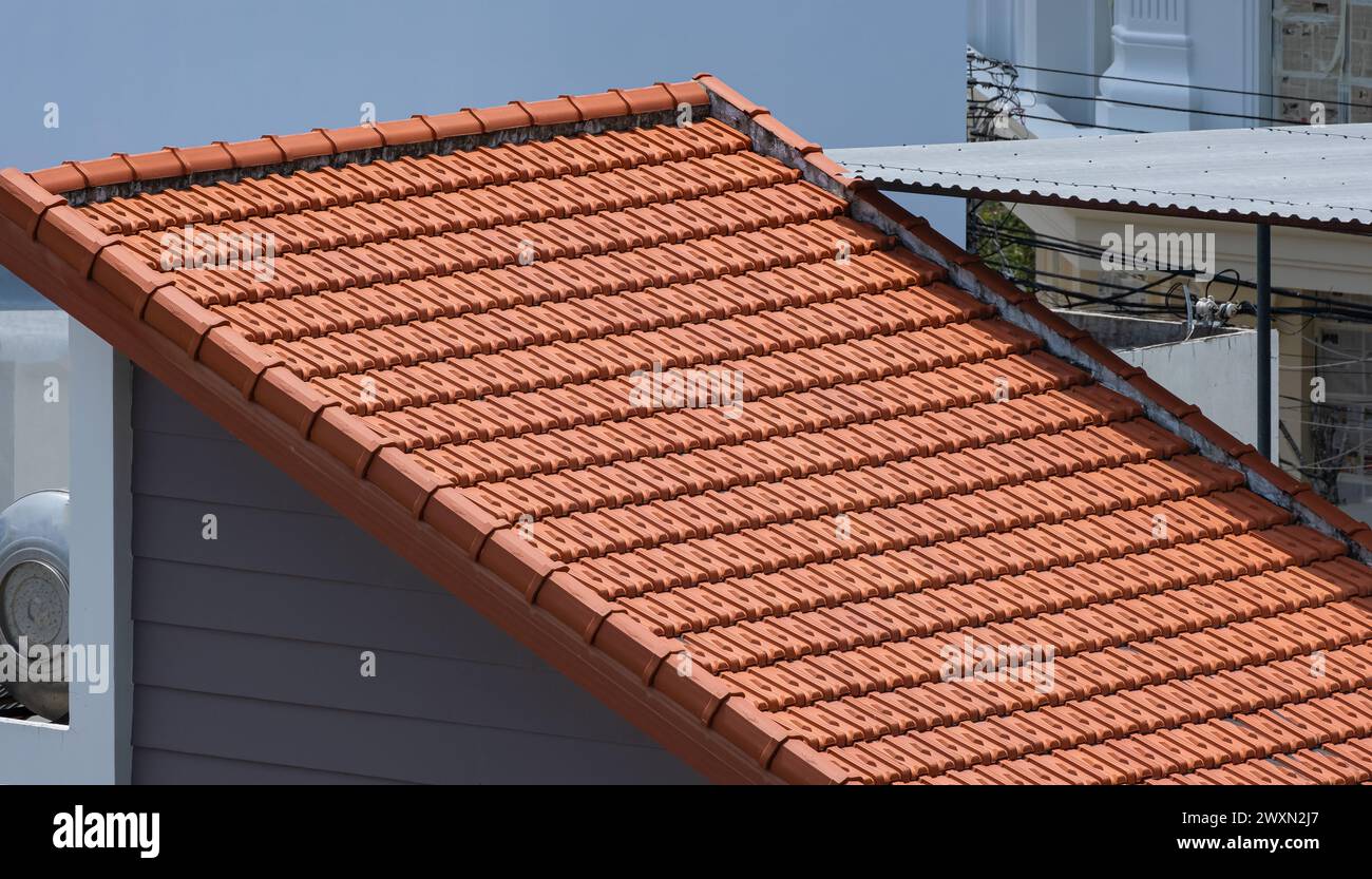Terracotta roof with ceramic tiles on old house. Close up Detail of Roof Tiles. Elements of the ...