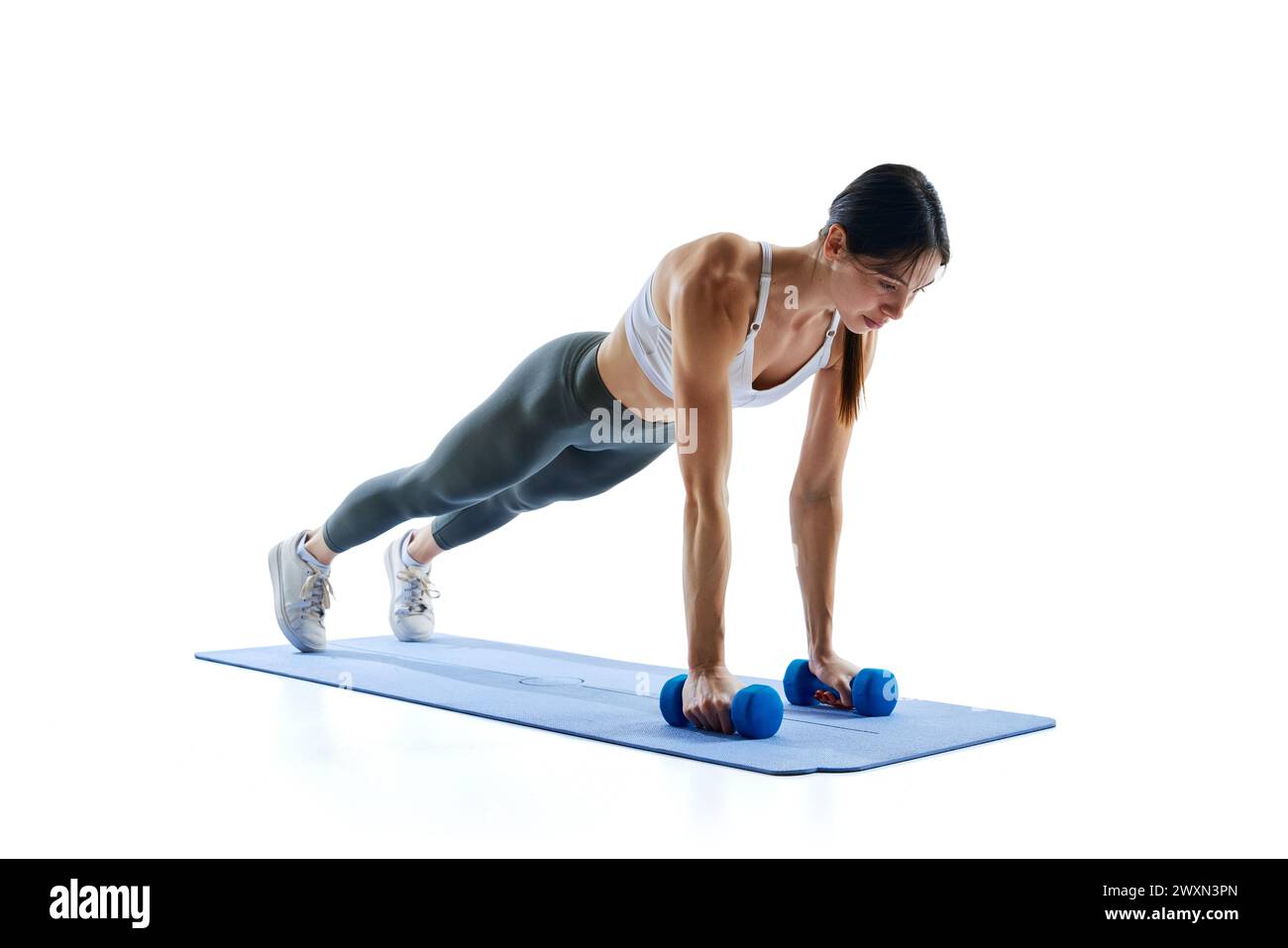 Young, fit, strong woman in legging and top doing push-ups with ...
