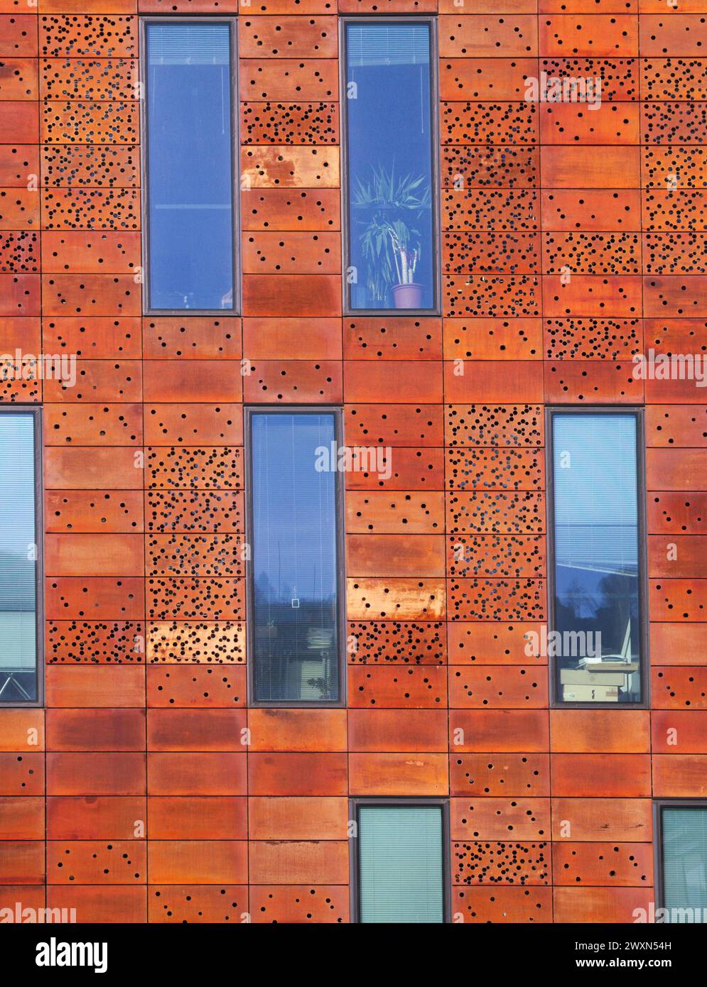 windows of a modern office building with perforated metal panels Stock ...