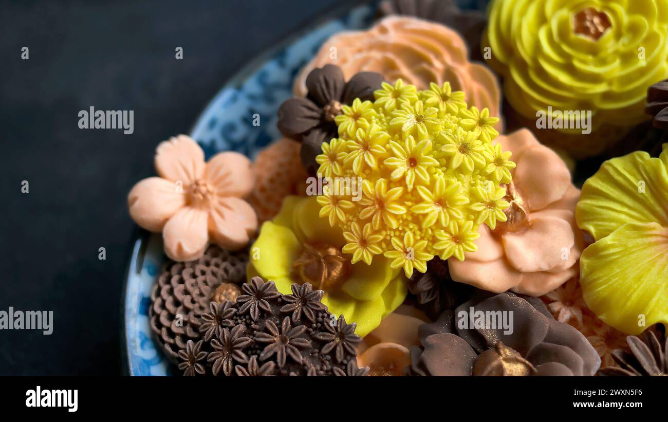 Thai dessert in various flower shaped, warm color tone, orange ...