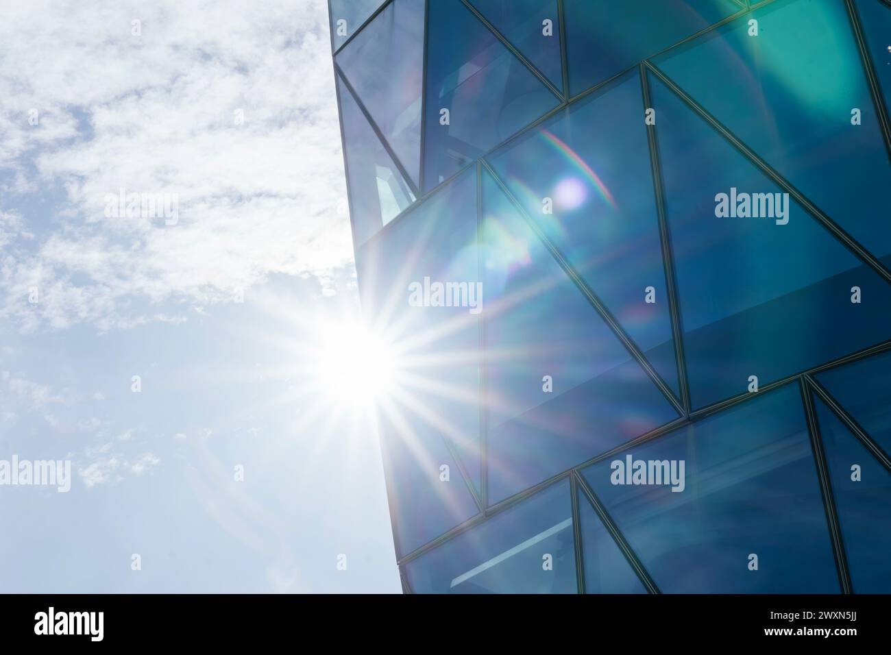 Corporate background of early morning sun rays illuminating a glass ...