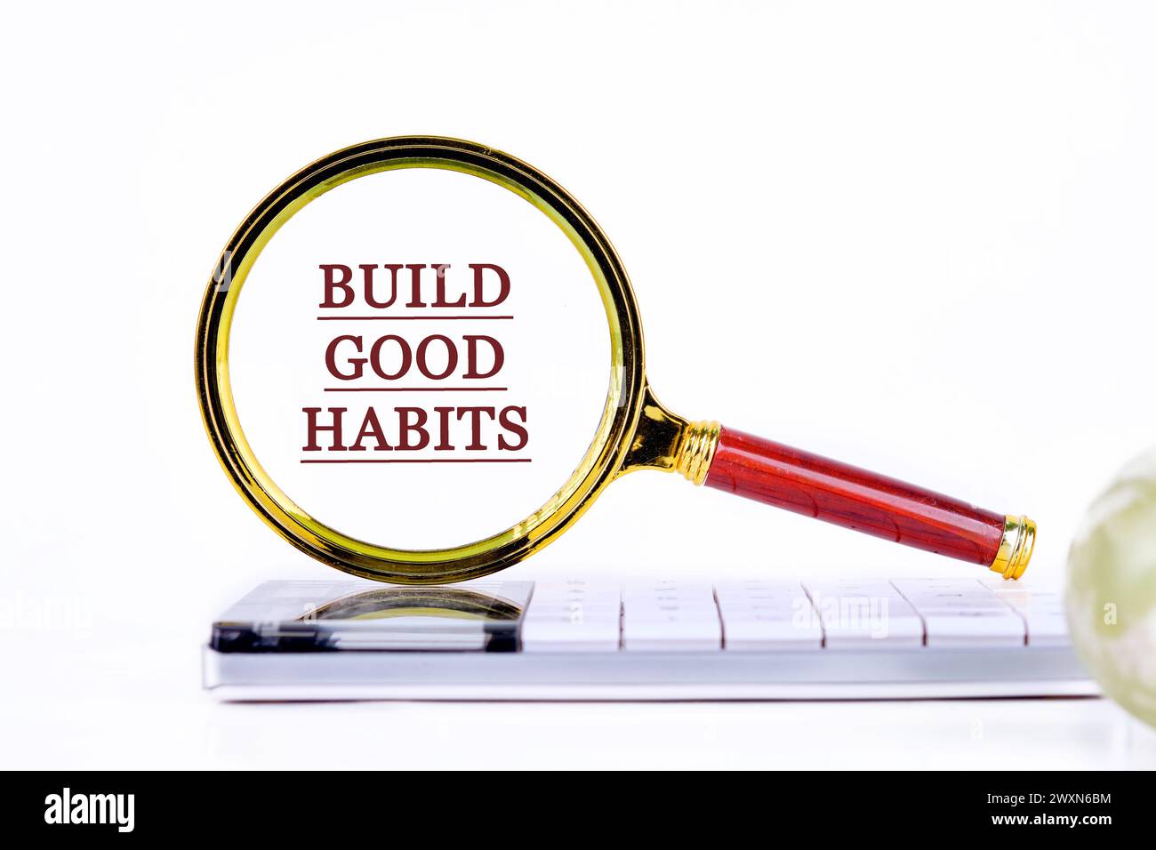 BUILD GOOD HABITS motivational concept text through a magnifying glass ...