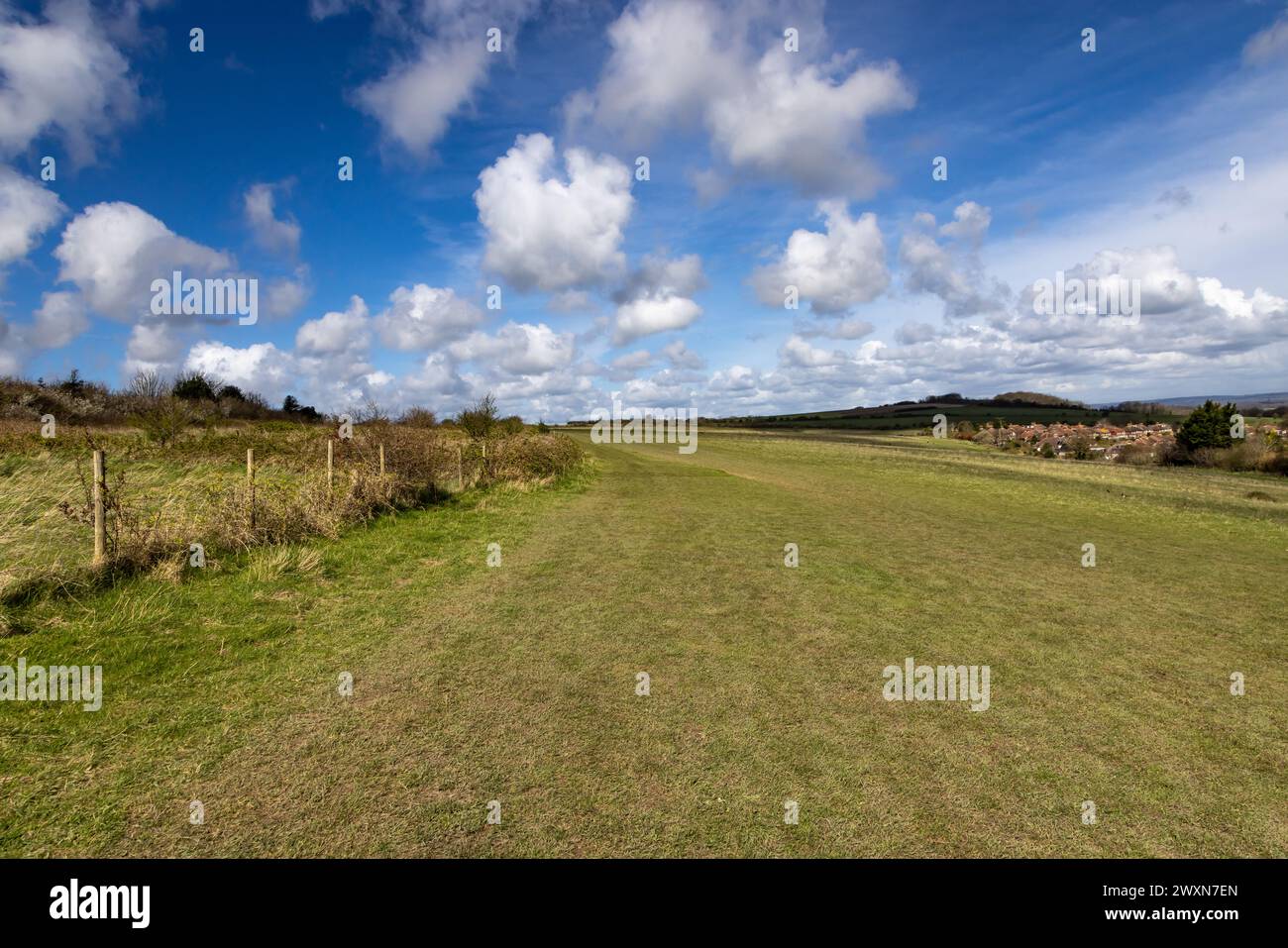 Looking along a wide grass pathway in the South Downs near Lewes, with ...