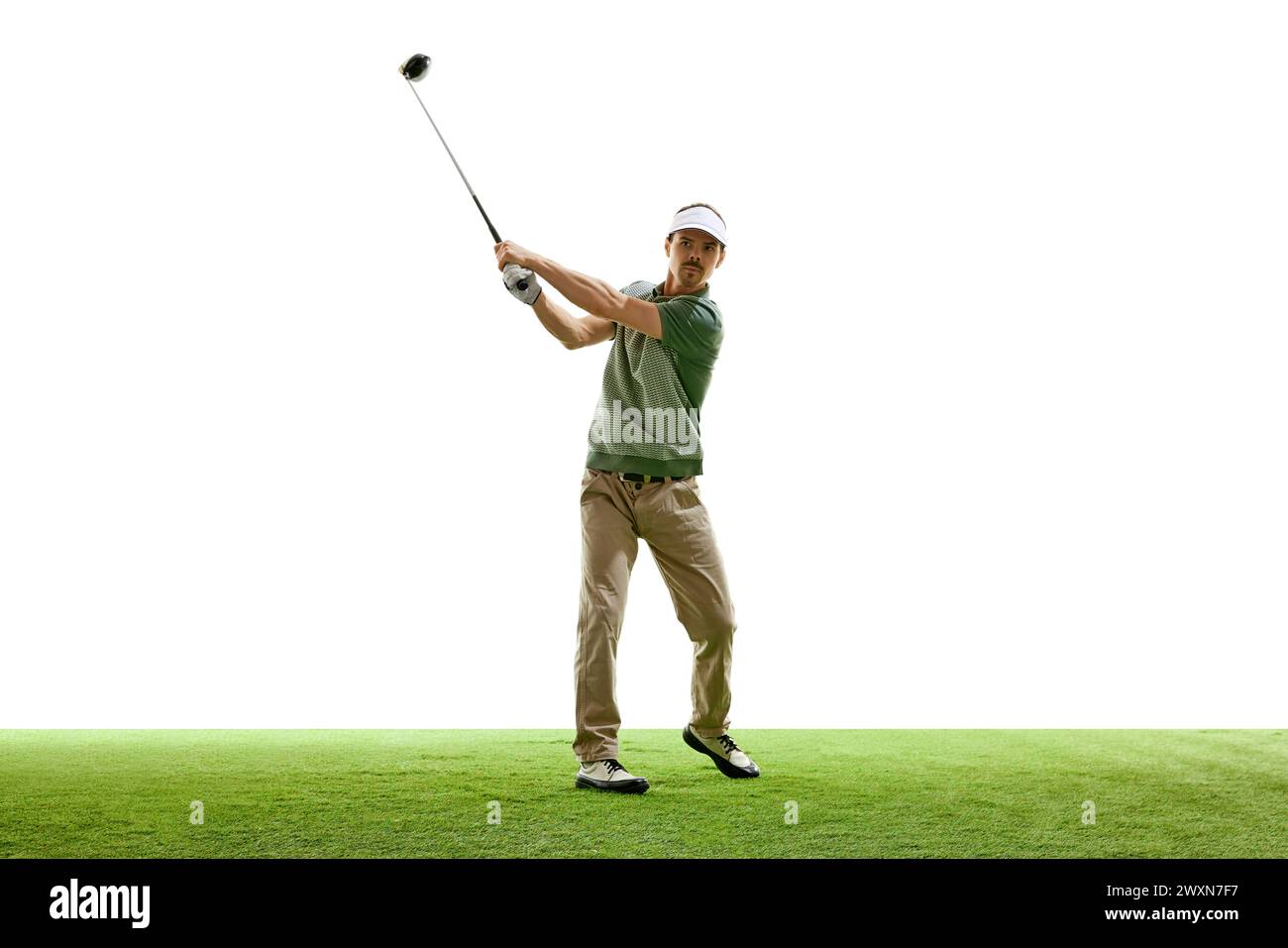 Professional golfer in casual attire in mid-swing with driver on ...