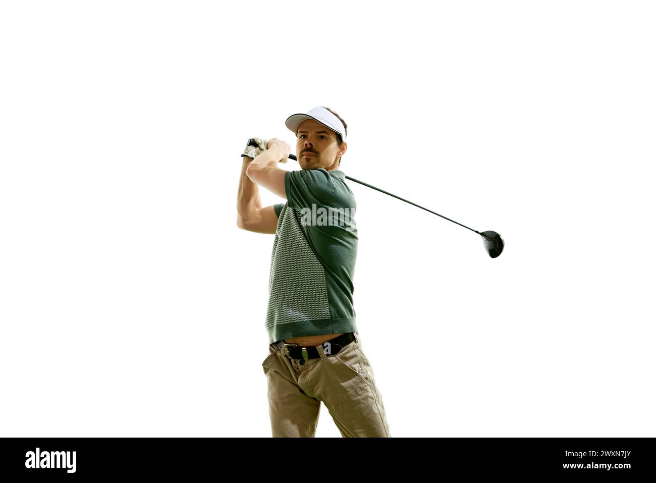 Athlete in golf attire doing perfect swing in motion and looking at ...
