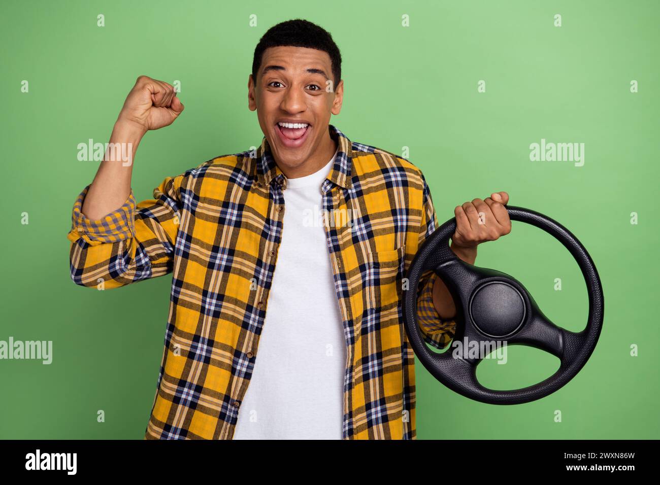 Photo of young positive guy celebrate he gets drivers license holding ...