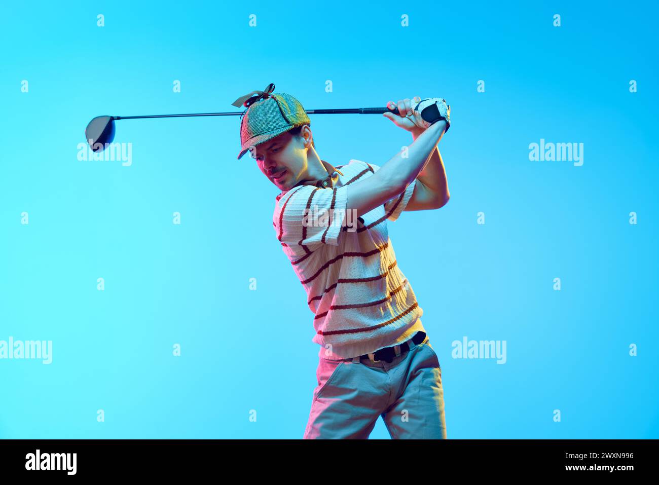 Golf player on professional golf course. Golfer in retro attire with ...