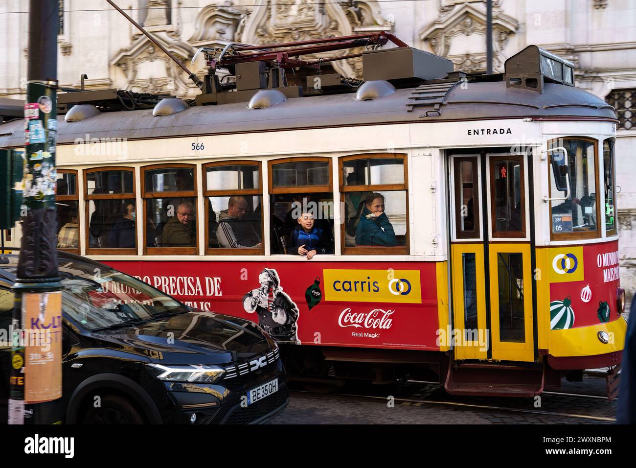 Red and Yellow Trolley Car Traveling Down Street. Lisbon, Portugal ...