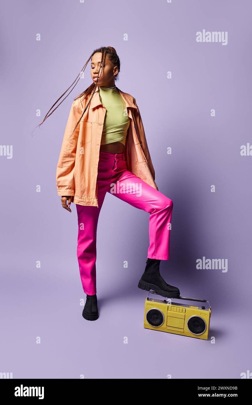 stylish african american girl with dreadlocks stepping on retro boombox ...
