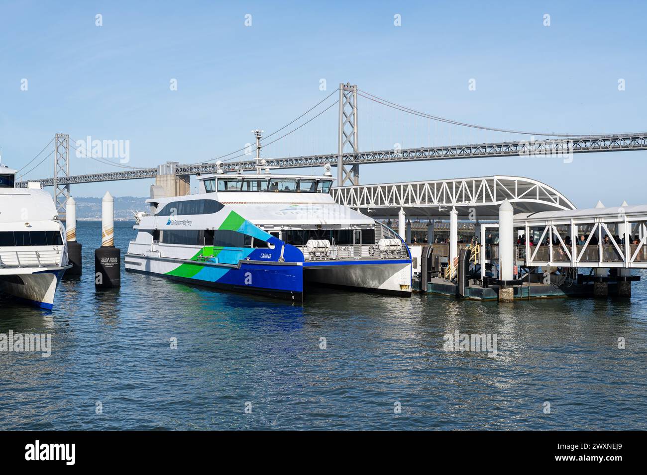 A San Francisco Bay Ferry with the Oakland Bay Bridge in the background ...