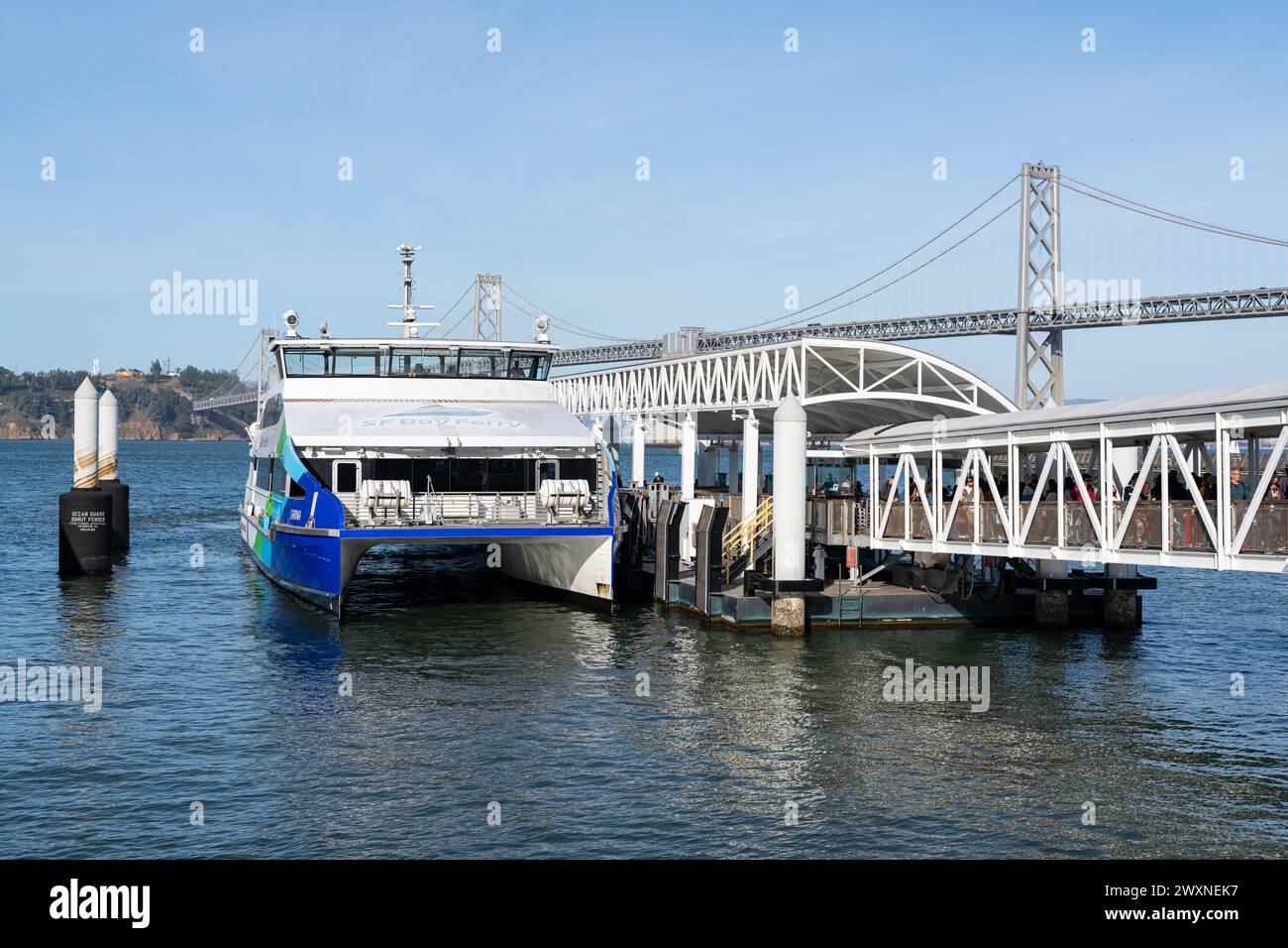 A San Francisco Bay Ferry with the Oakland Bay Bridge in the background ...