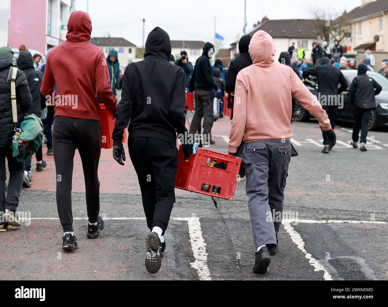 A group of young men carrying crates of petrol bombs at the start of an ...