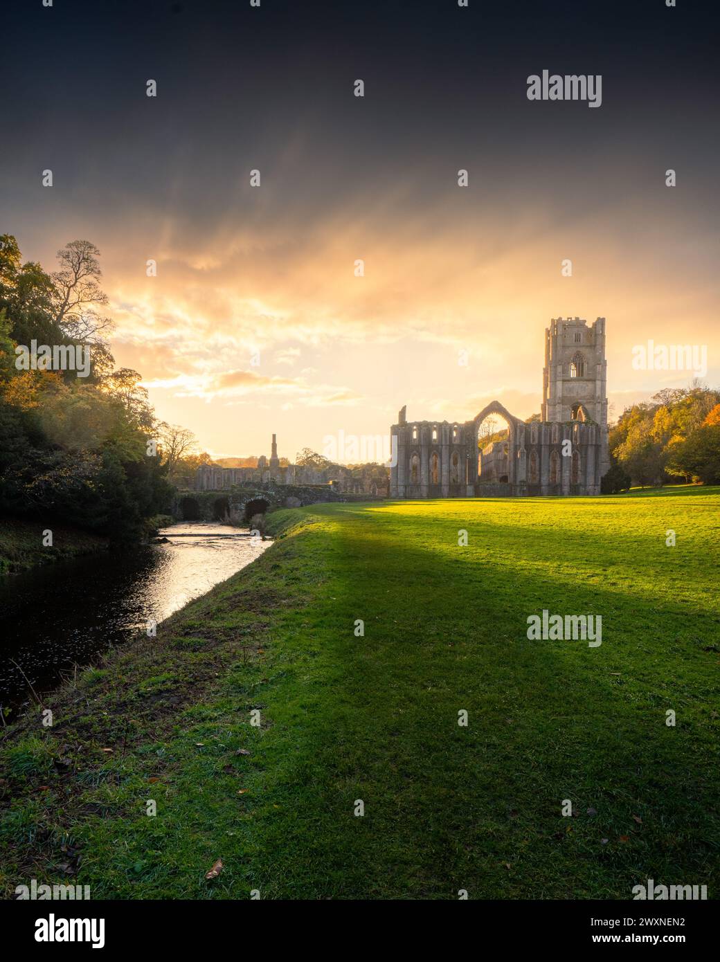 Fountains Abbey at Sunset: A historic masterpiece bathed in the warm ...