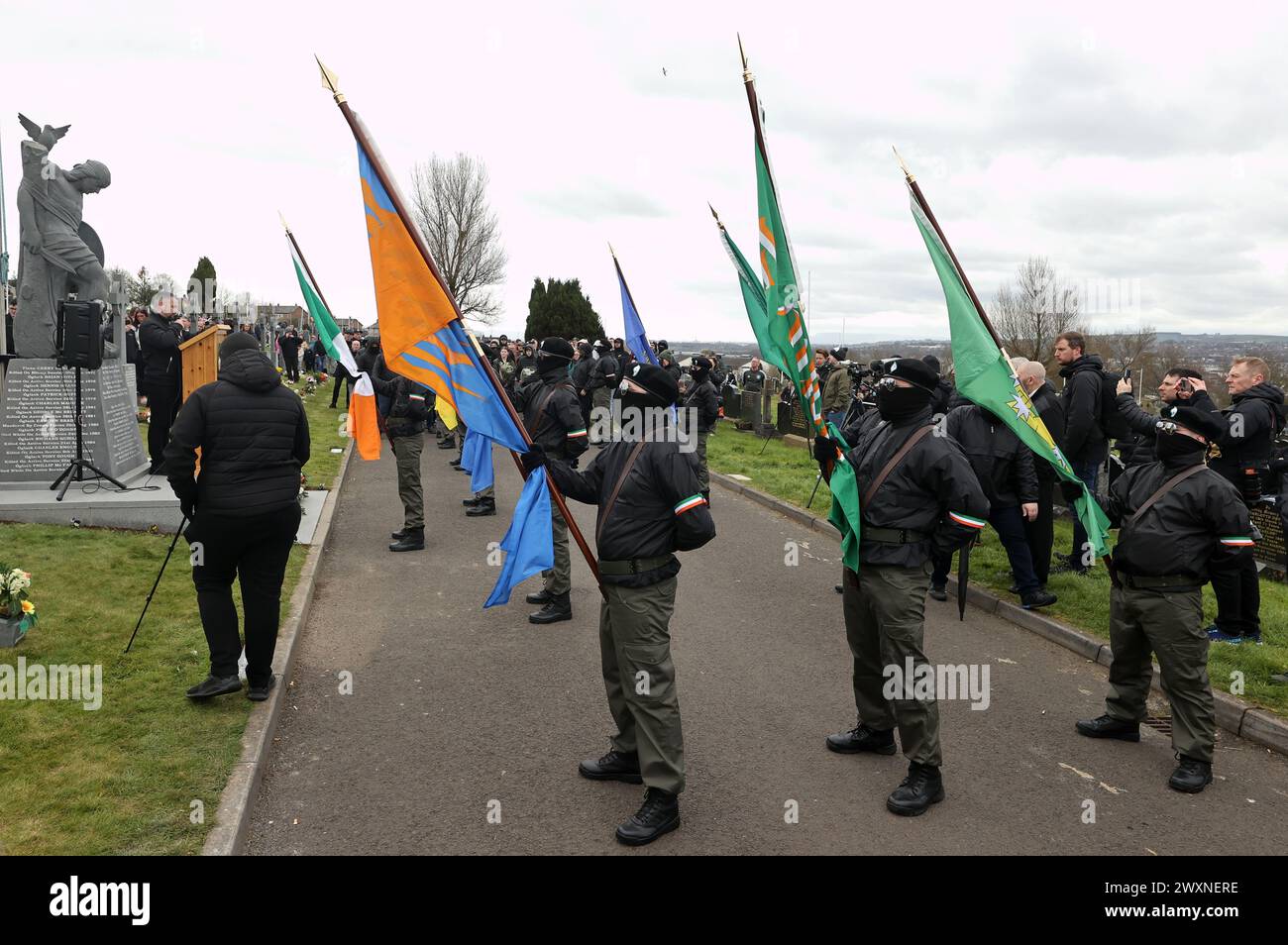 A colour party listen to a speaker at the City Cemetery in Londonderry ...