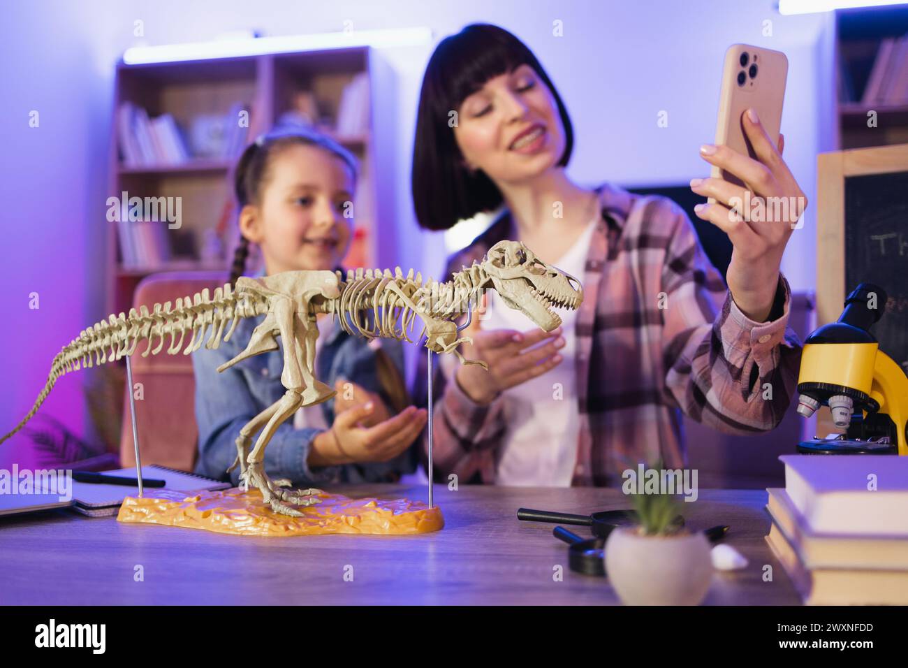 Young woman and little cute girl filming video of their scientific ...