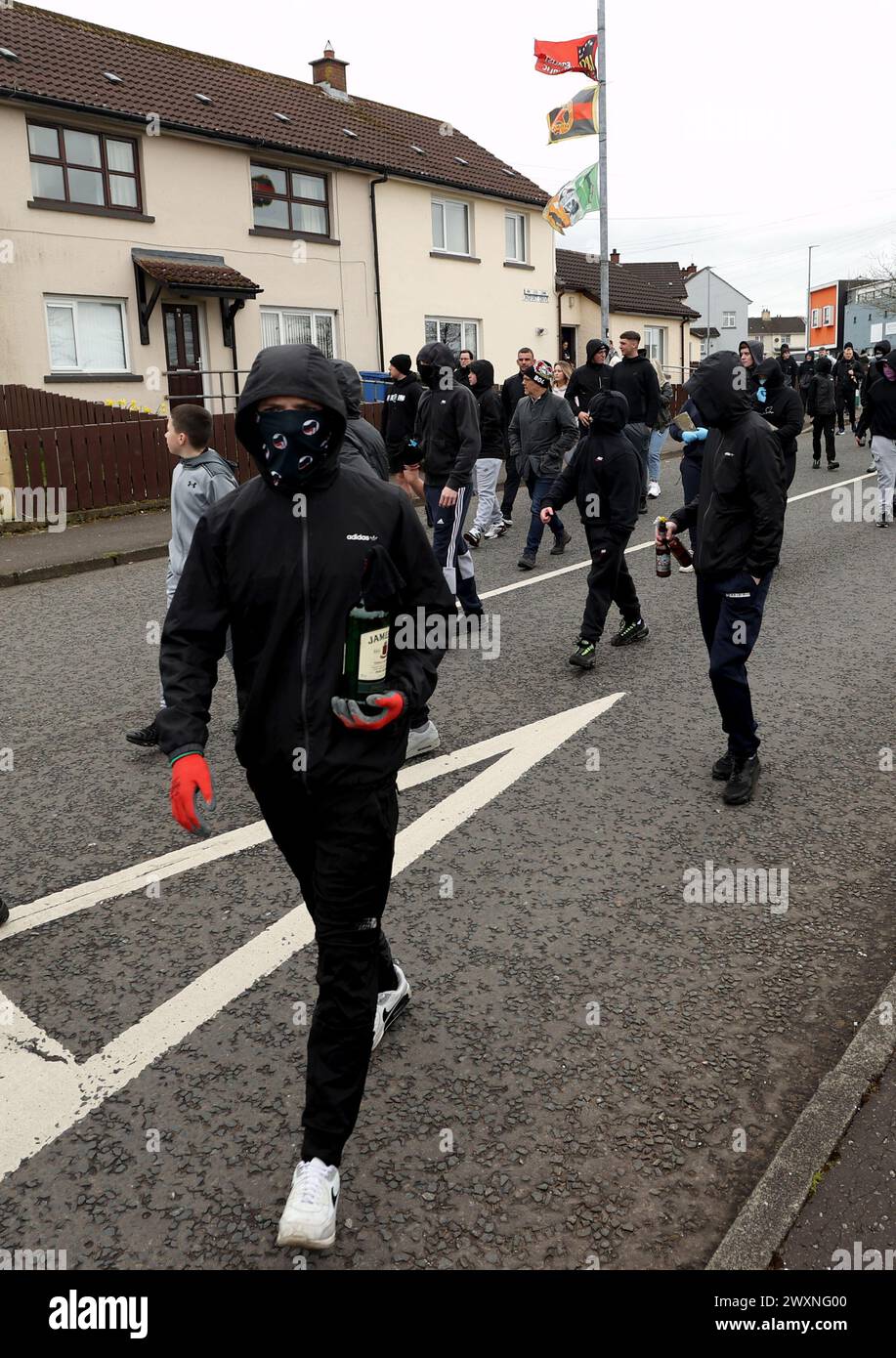 A young men carrying petrol bombs at the start of an Easter Monday ...