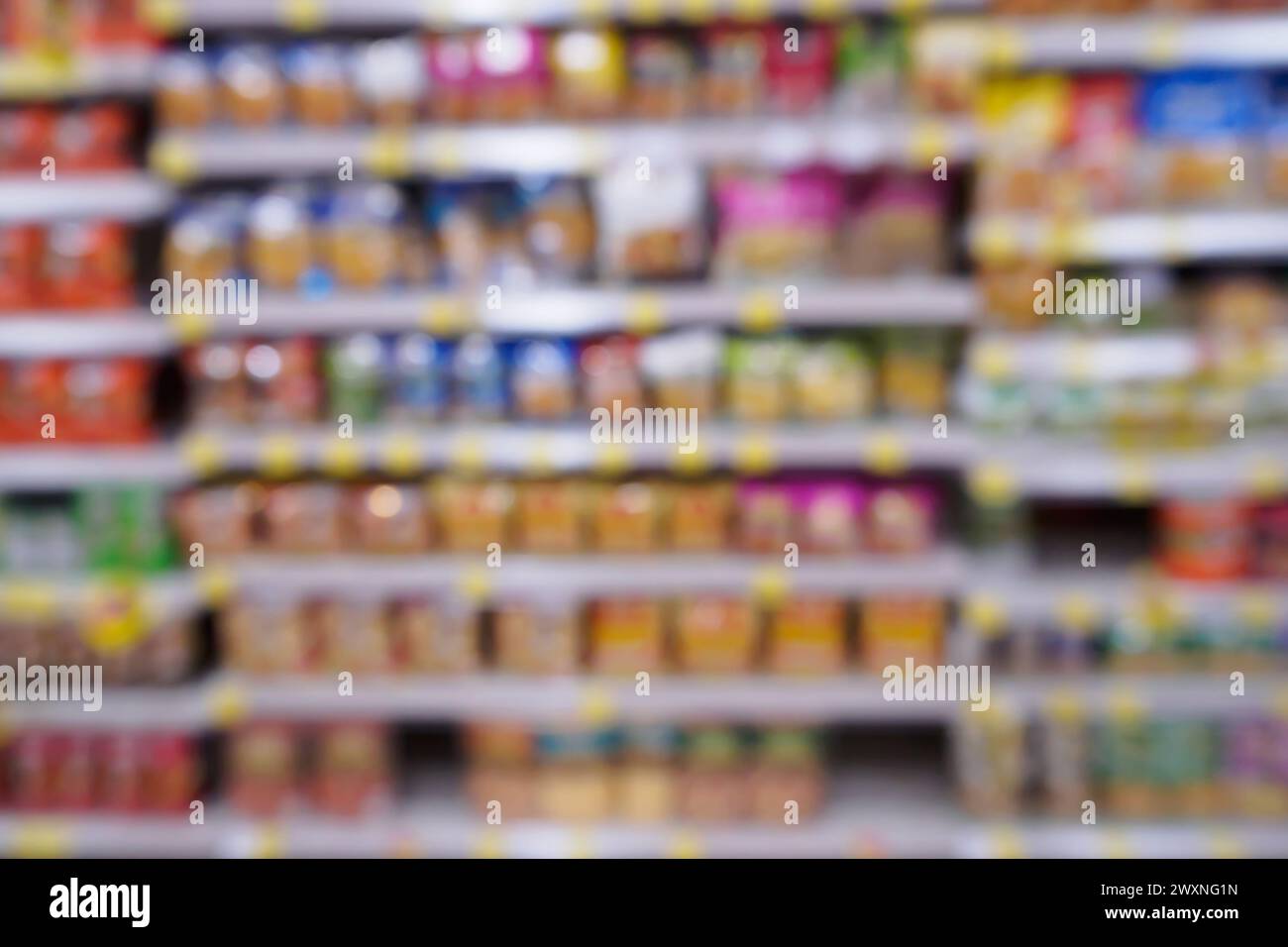 Abstract blur supermarket with variety of fast food snacks chips ...