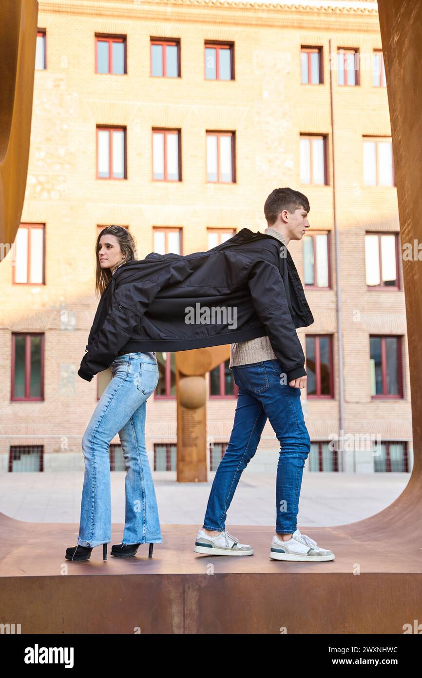 vertical photograph of a couple sharing a coat Stock Photo - Alamy