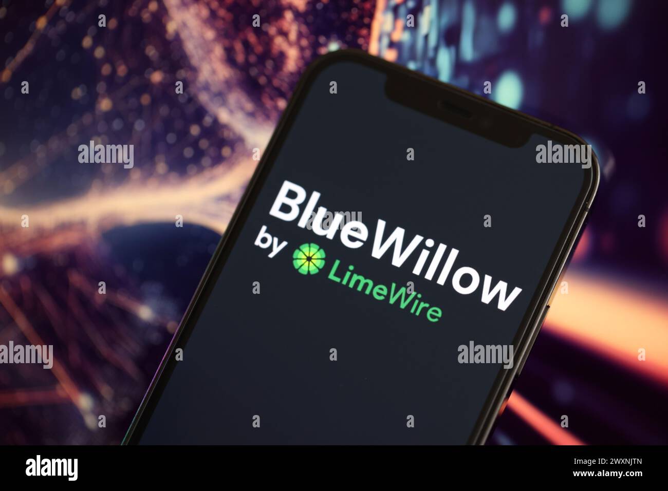 KYIV, UKRAINE - MARCH 17, 2024 BlueWillow logo on iPhone display screen with background of ...