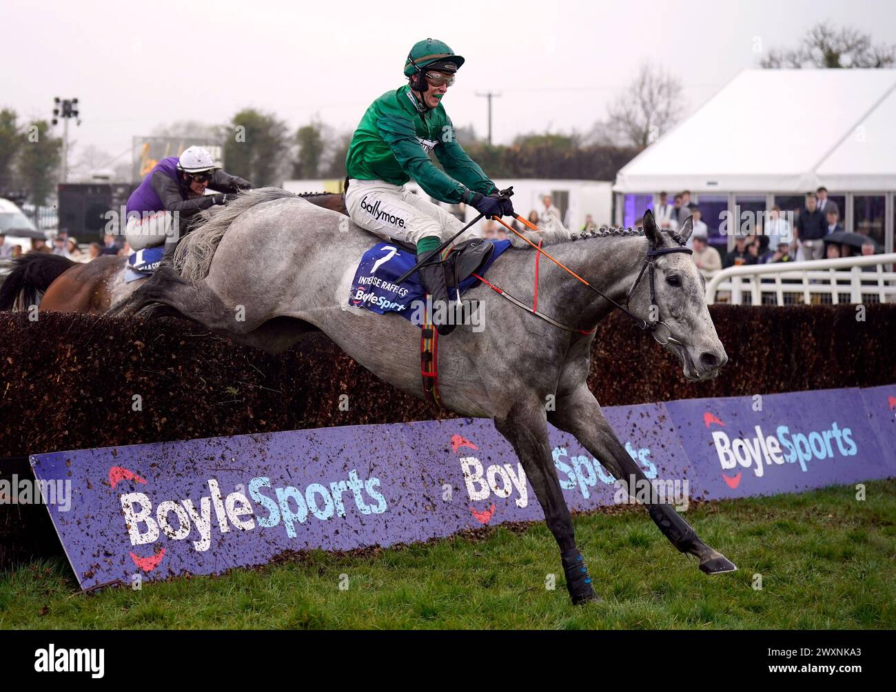 Intense Raffles ridden by jockey J J Slevin clear a fence on their way ...