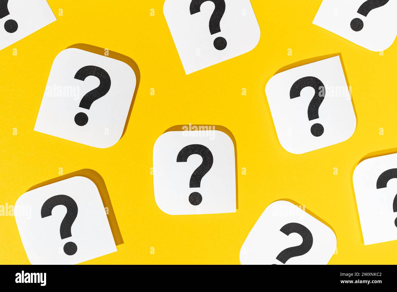 Many Question marks signs on yellow background Stock Photo - Alamy