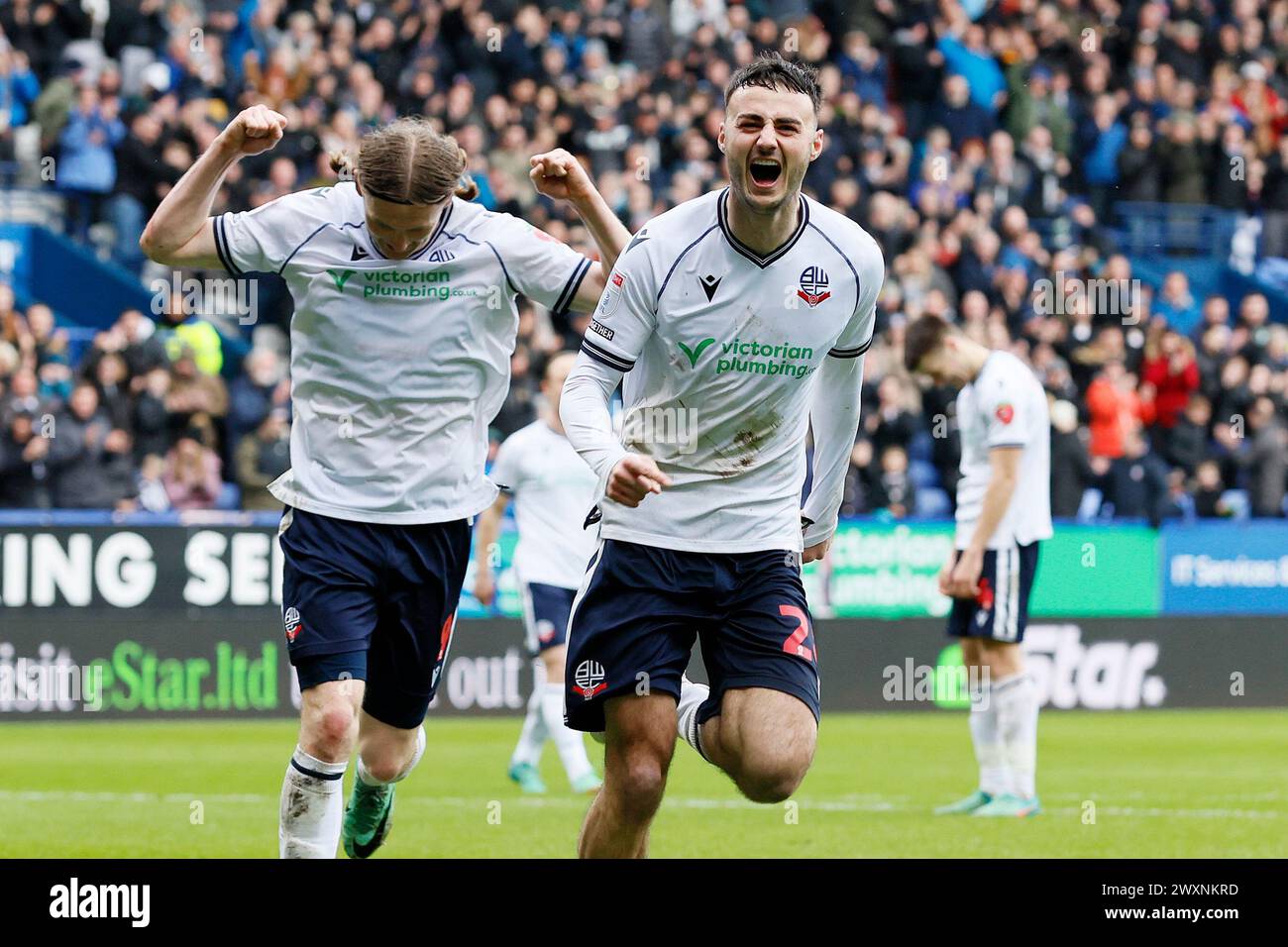 Bolton Wanderers' Aaron Collins (right) celebrates scoring their side's ...
