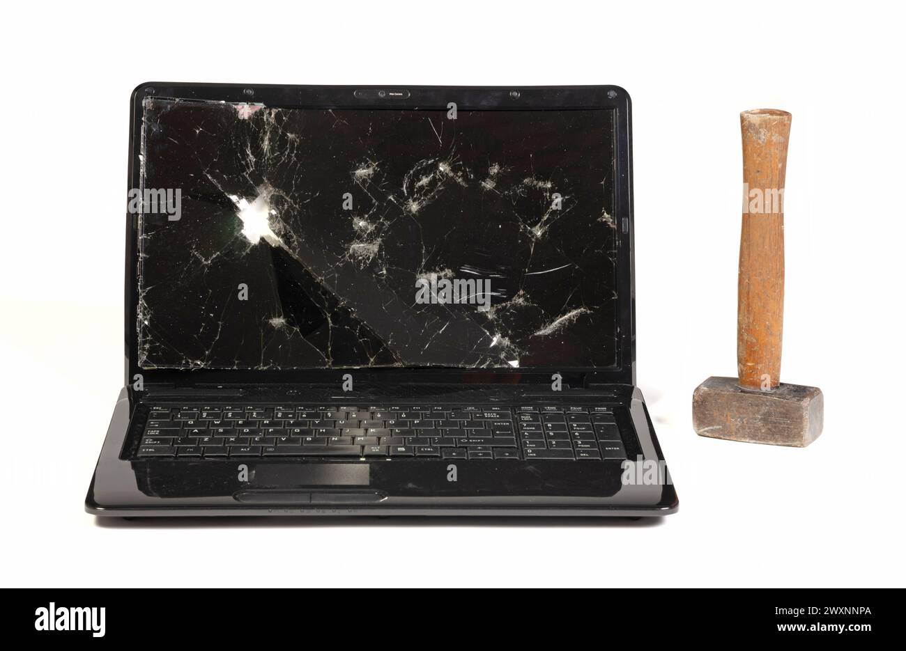Old broken laptop isolated on white a background, broken with hammer ...