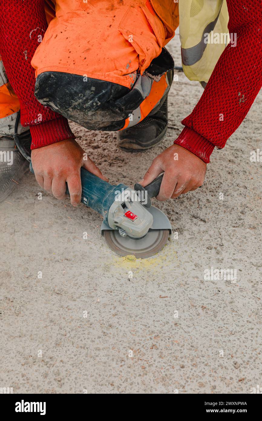 A man grinding concrete floor with power tool Stock Photo - Alamy